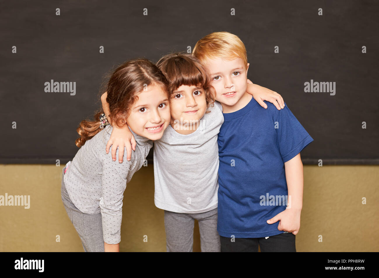 Three children stand High Resolution Stock Photography and Images - Alamy