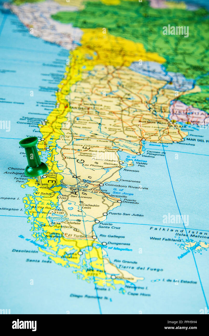 closeup of draw-pin stick into real map, travelling to Chile ...
