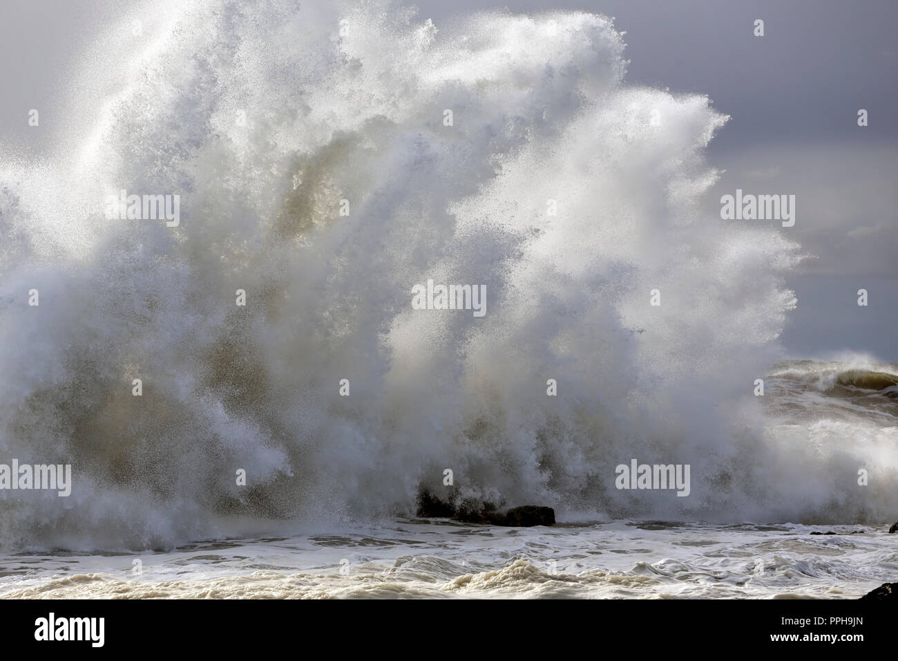 Sea wave splash. Rocky beach from the north of Portugal. Sky before ...