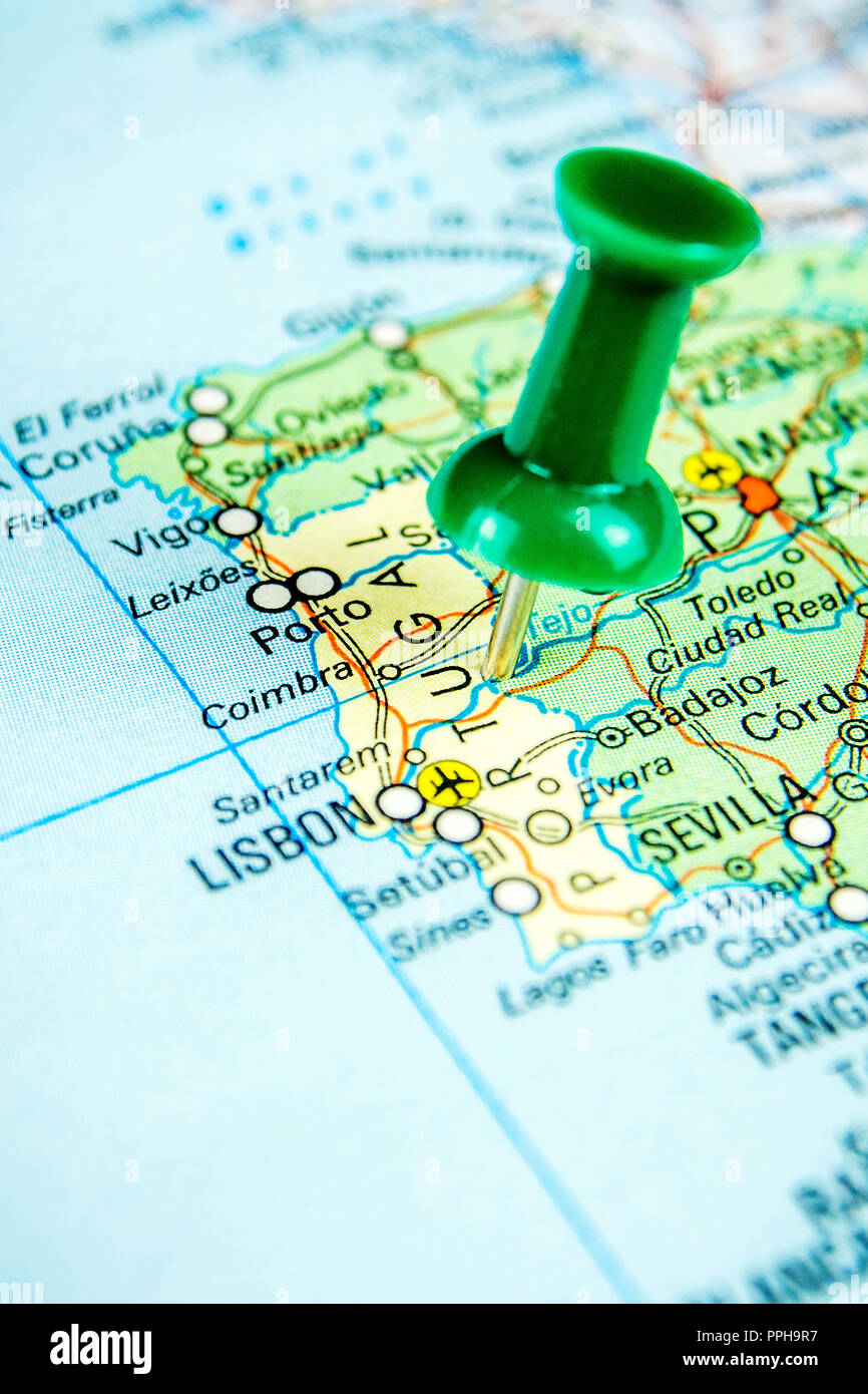 closeup of draw-pin stick into real map, travelling to Portugal ...