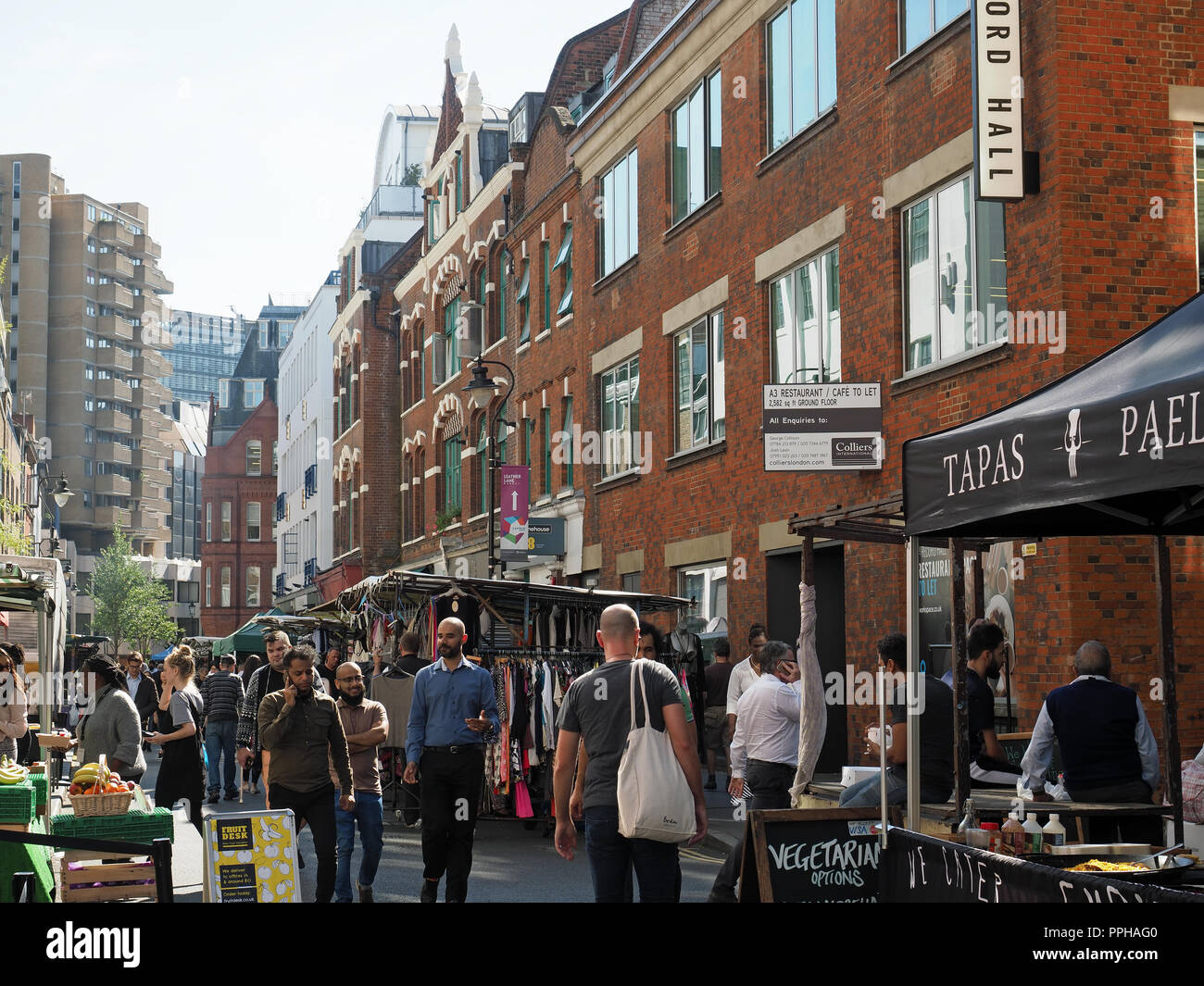View along the street market and food stalls in Leather Lane London ...