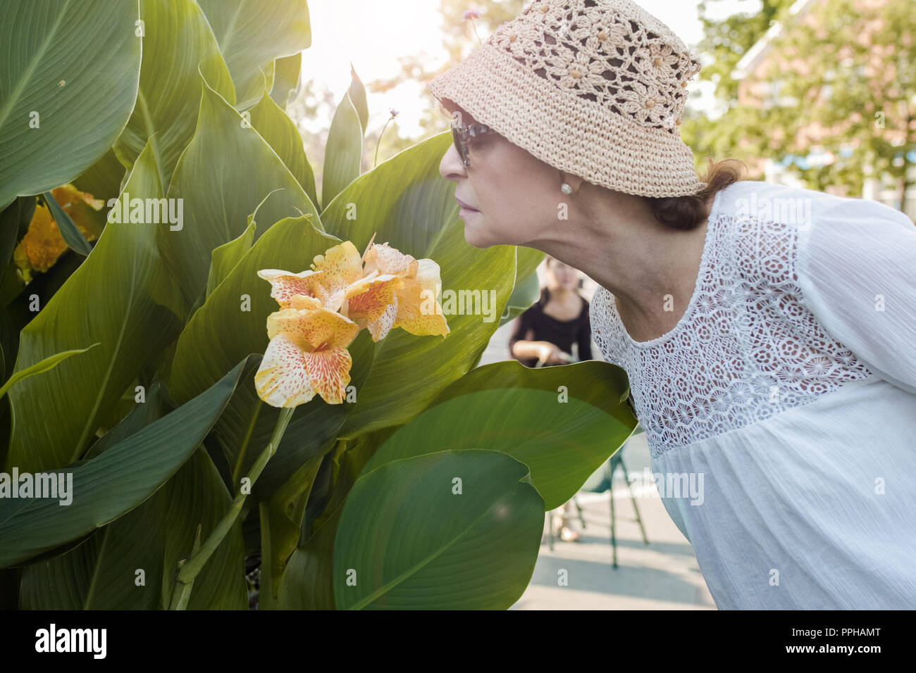 Lady smells flowers hi-res stock photography and images - Alamy