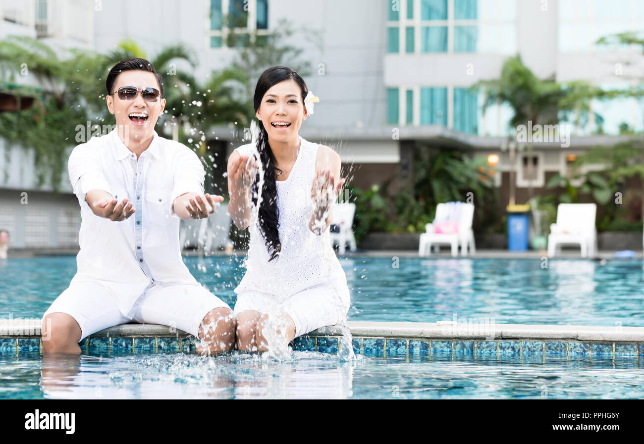Couple enjoying on swimming pool Stock Photo - Alamy