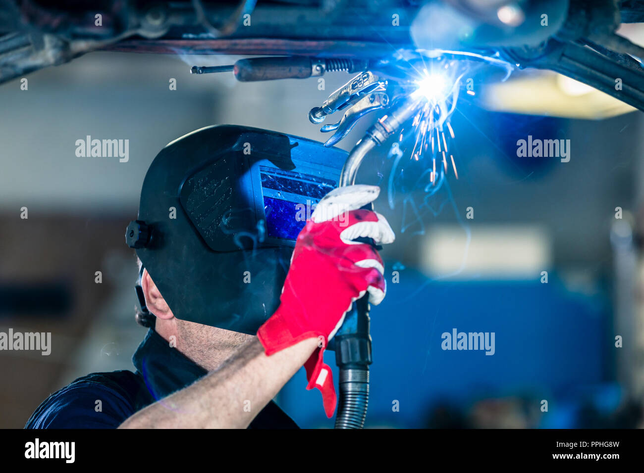 Male welds the automotive part in car factory Stock Photo - Alamy