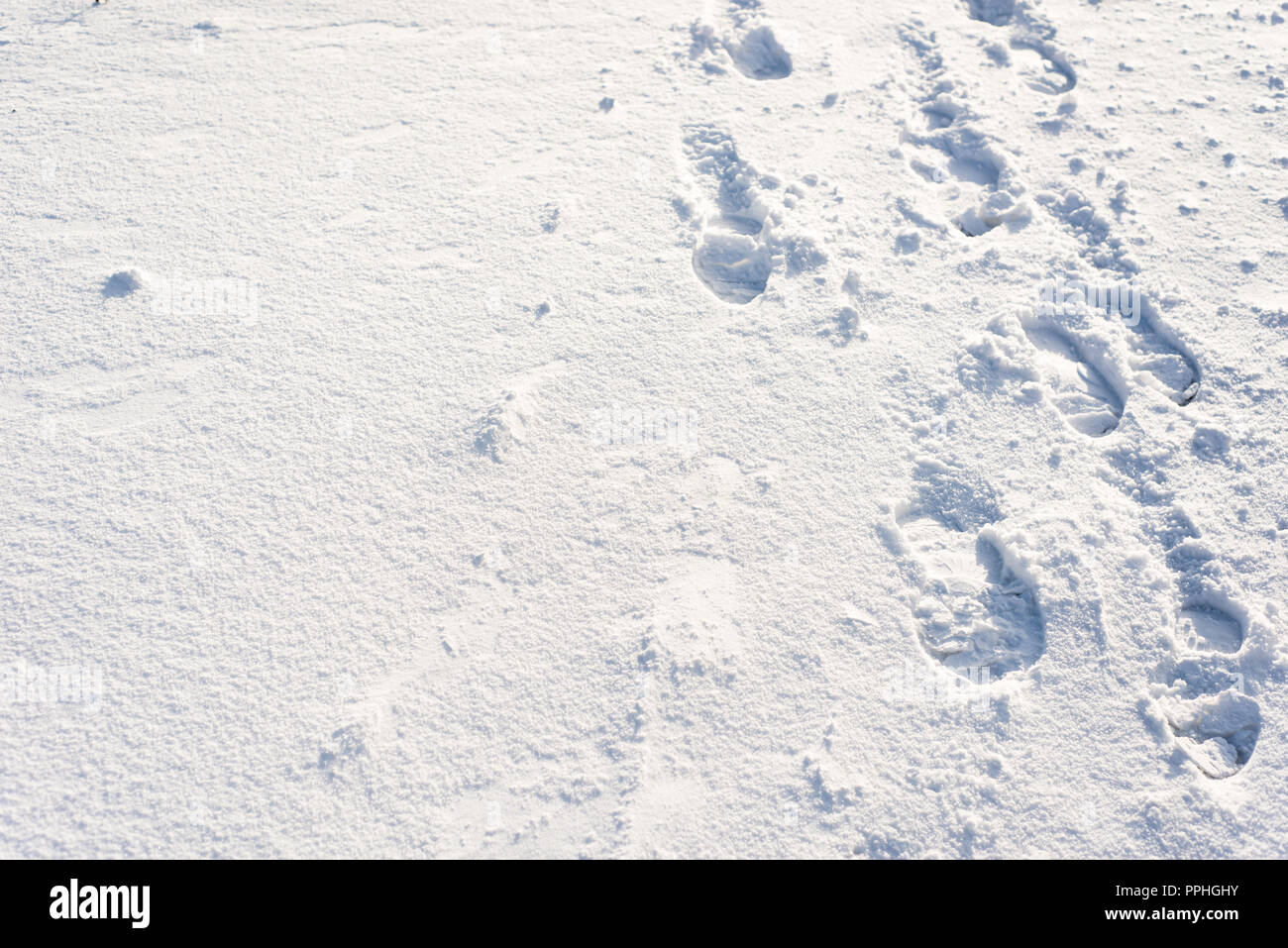 Footprints in snow, winter background Stock Photo - Alamy