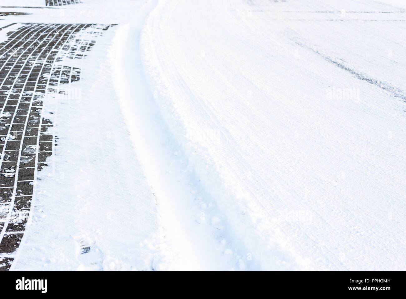 Background with snow on road in winter and footpath paving, texture ...