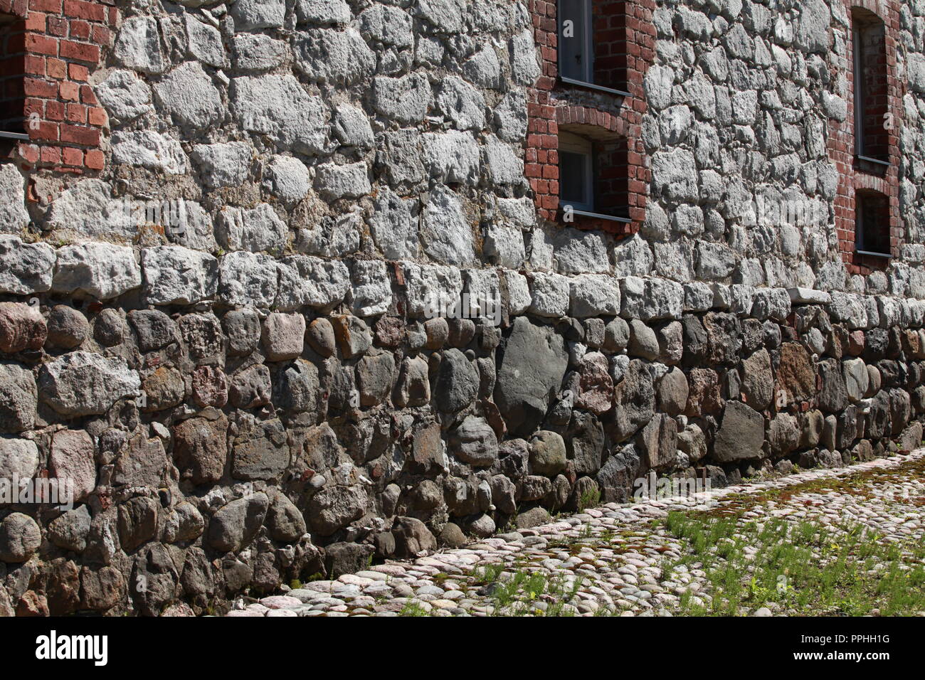 medieval city cobblestone pavement, stone wall Stock Photo - Alamy