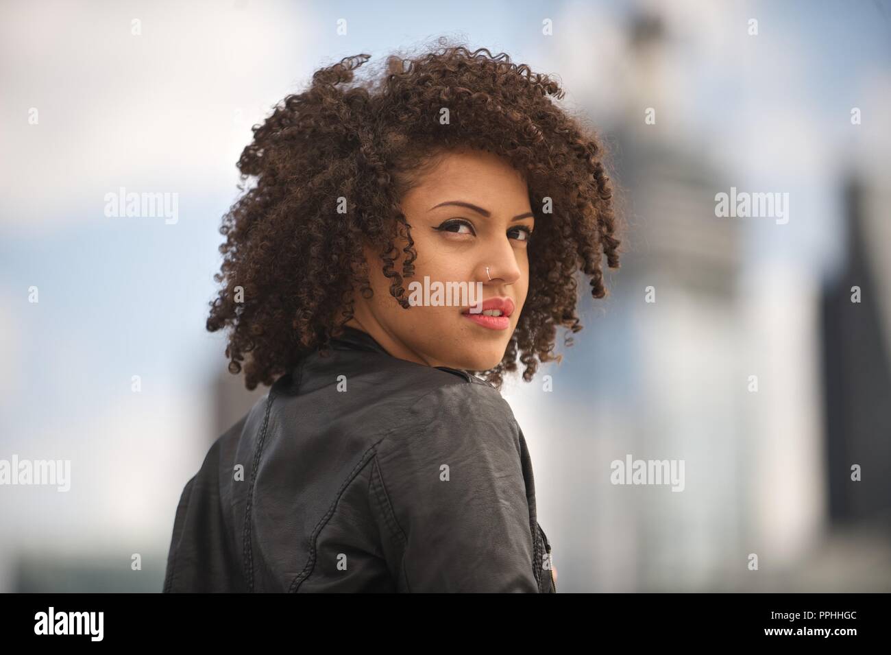 Beautiful mixed race model relaxing outside Stock Photo - Alamy