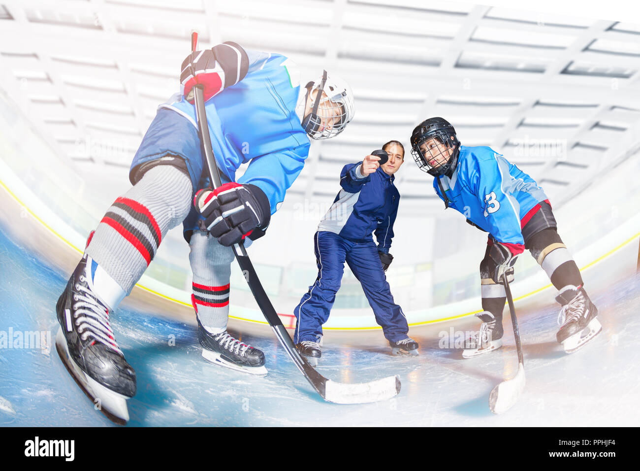 Young hockey players and coach dropping puck Stock Photo - Alamy