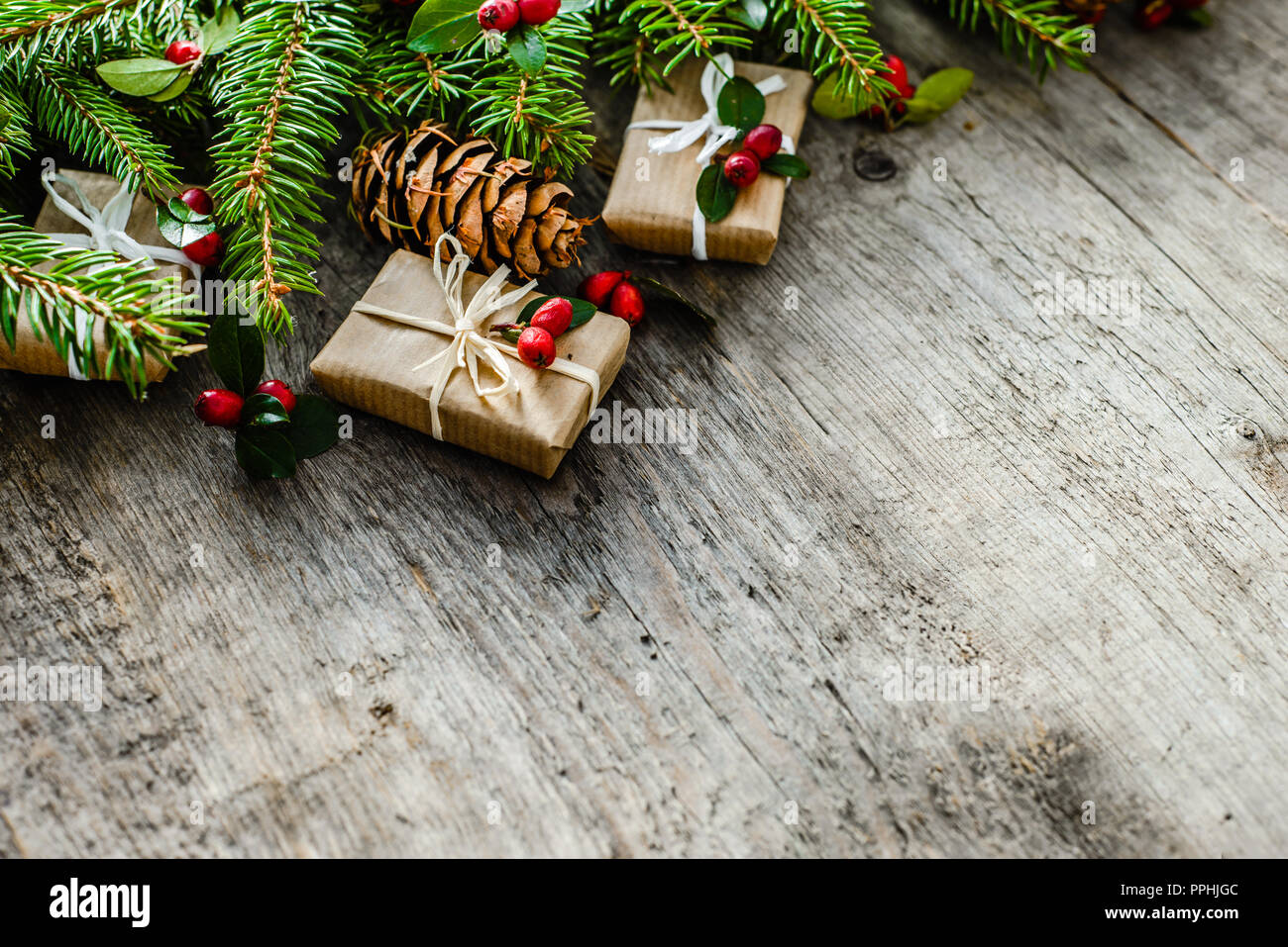 Border with christmas decorations on fir tree and gift boxes on wooden ...