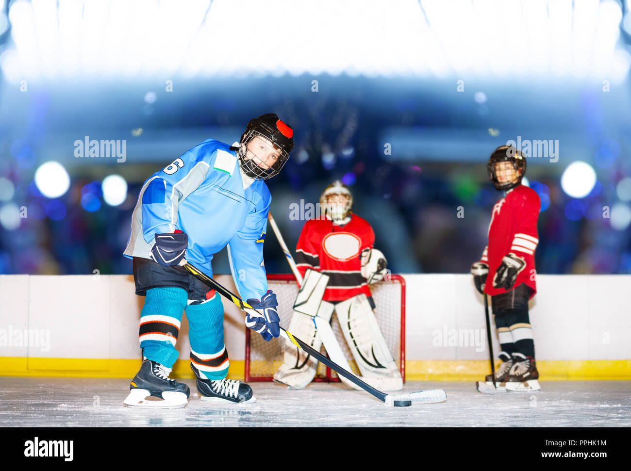 Young defenseman passing puck during hockey match Stock Photo - Alamy