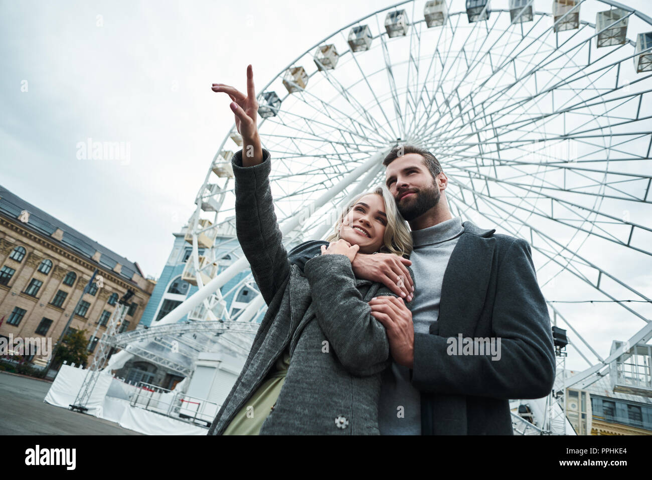 Romantic date outdoors. Young couple standing at entertainment park ...