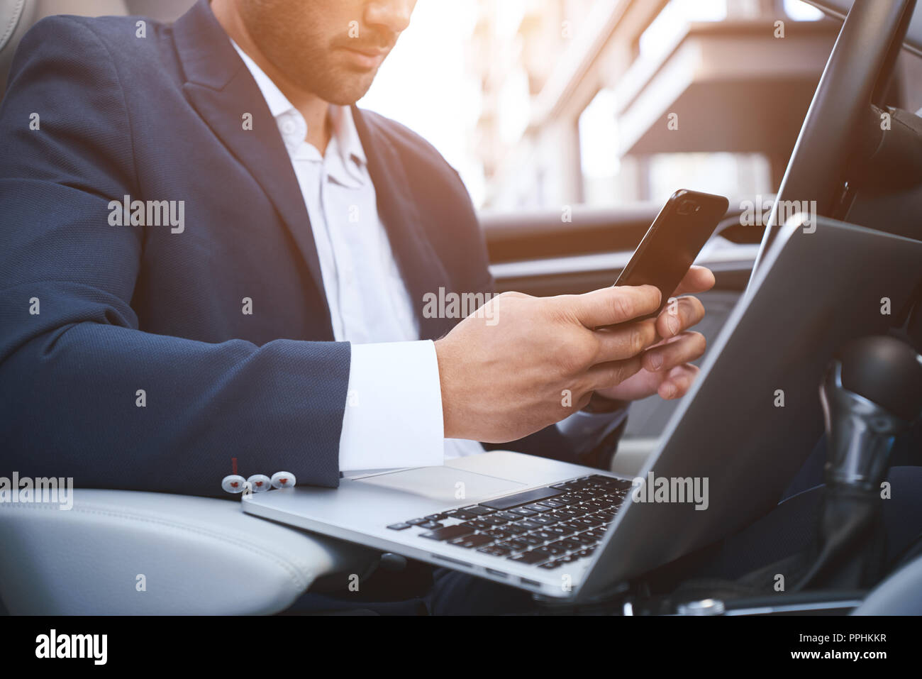 Close-up of a confident businessman getting ready in a car for a Stock ...