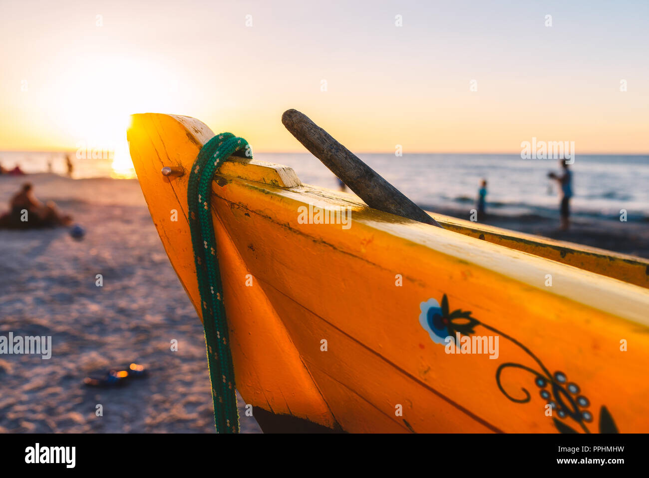 Bow of the fishing boat on the beach during sunset Stock Photo - Alamy