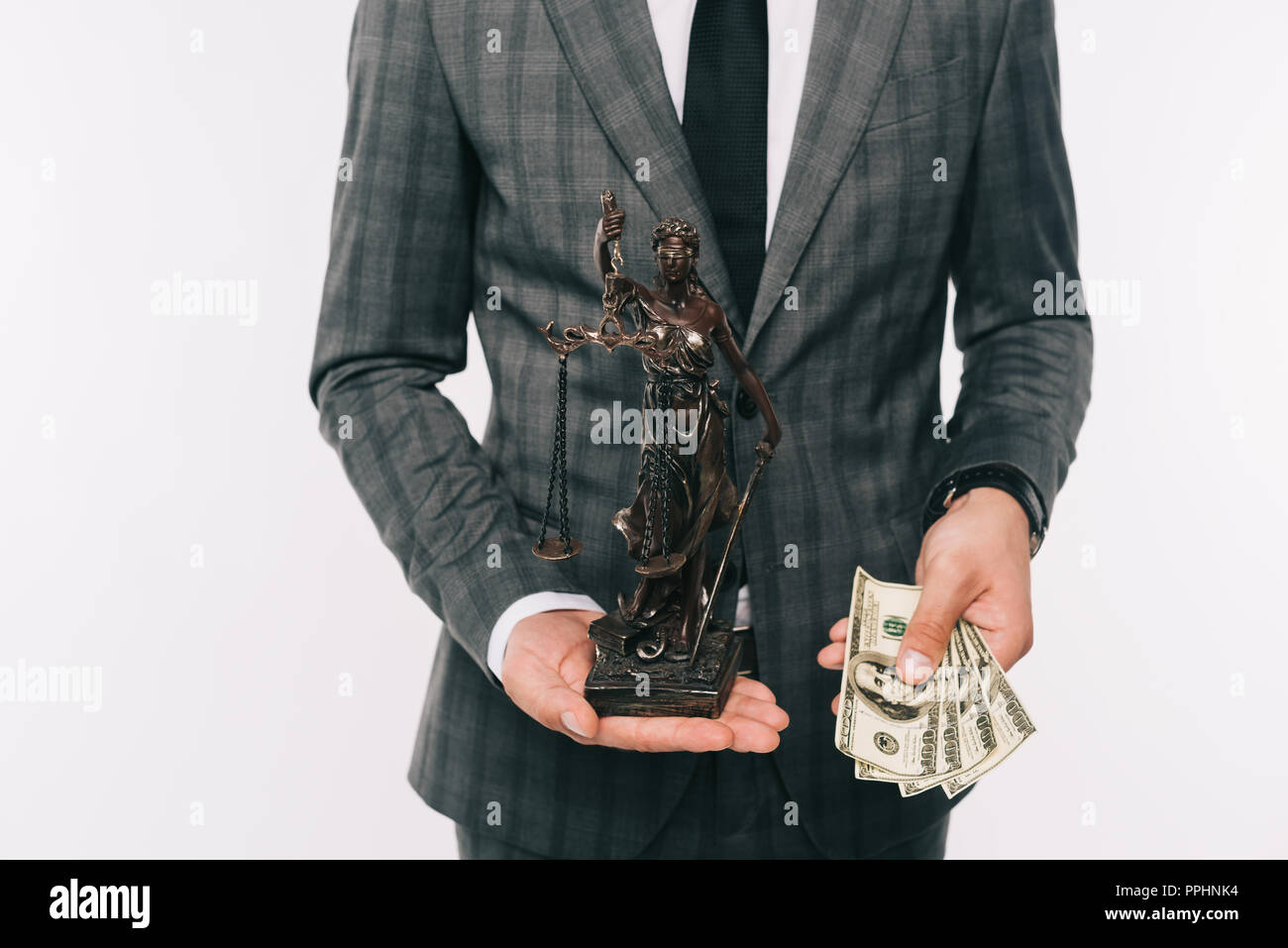 cropped image of businessman holding lady justice statue and cash ...