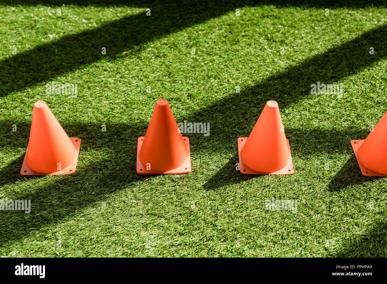 high angle view of row of safety cones standing on grass field Stock ...