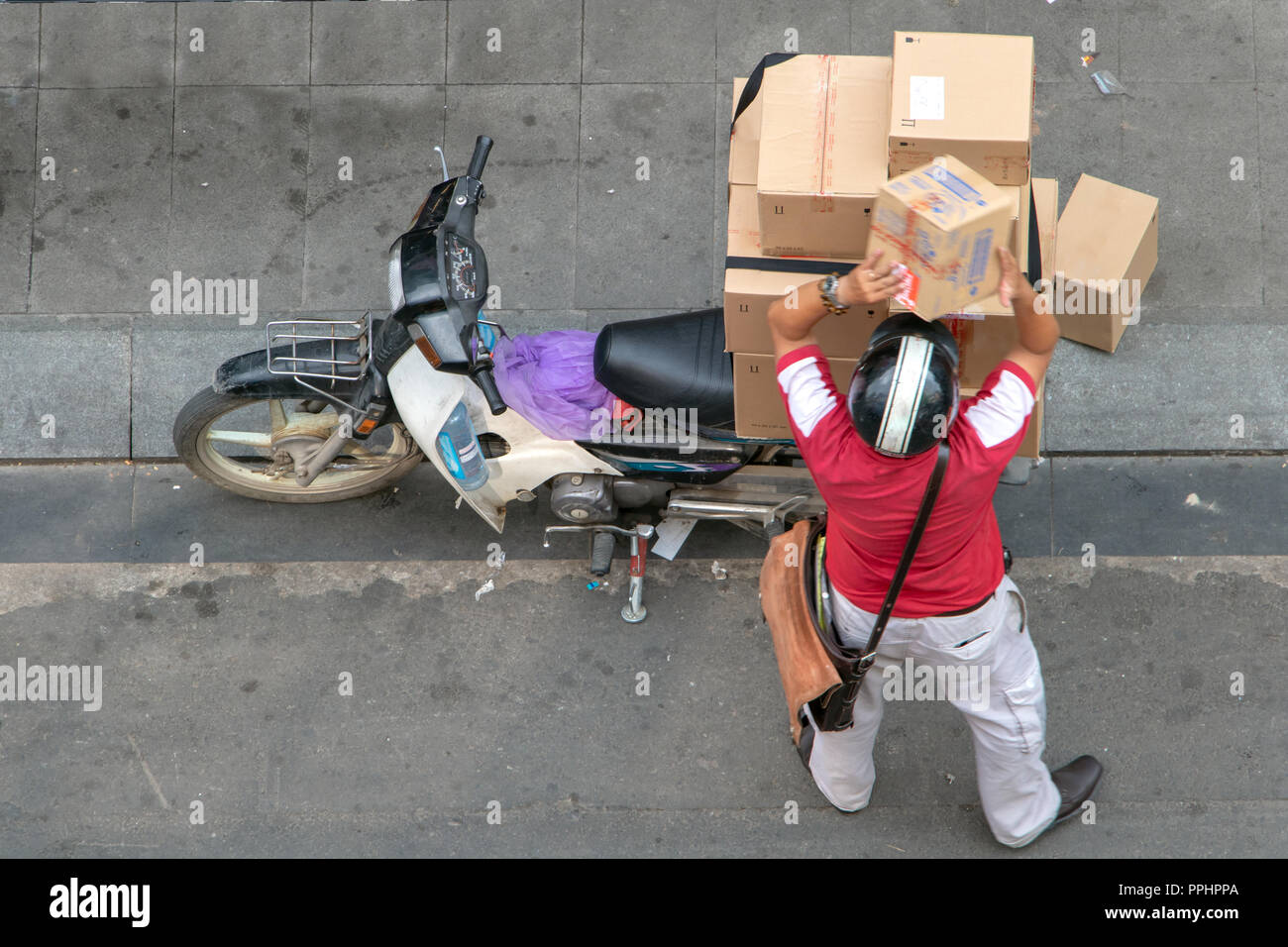 Delivery of consignments on motorbike. Motorcyclist with the many ...