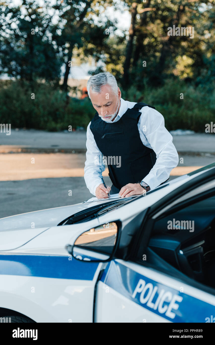 Mature male officer writing hi-res stock photography and images - Alamy