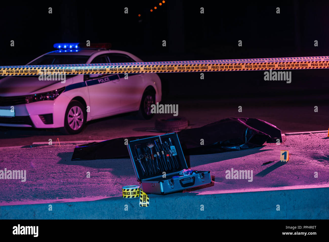toned picture of crime scene with police car, case with investigation ...