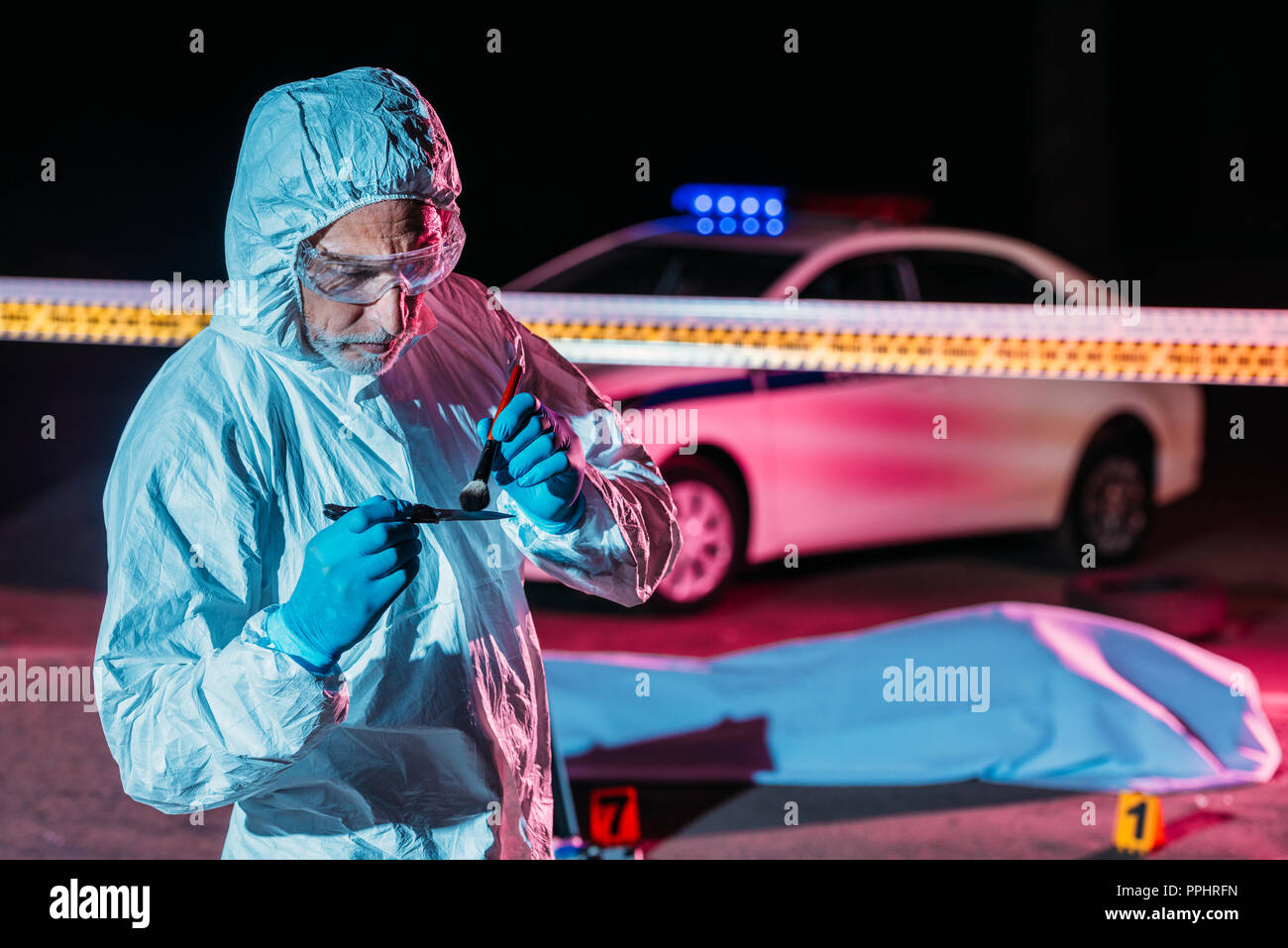 Concentrated Mature Male Criminologist In Protective Suit And Latex