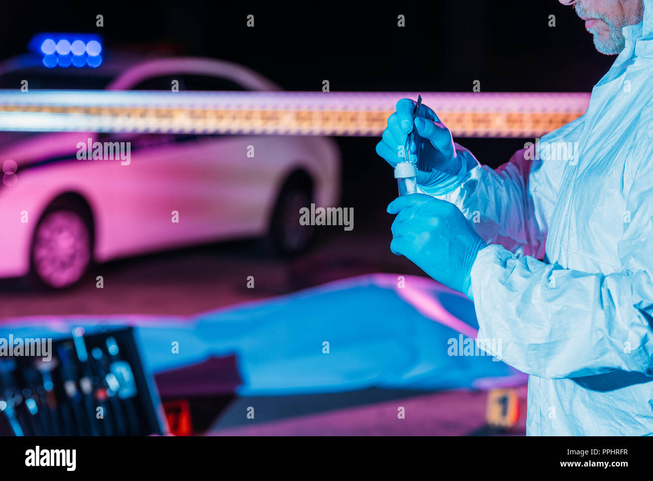 Partial View Of Male Criminologist In Protective Suit And Latex Gloves