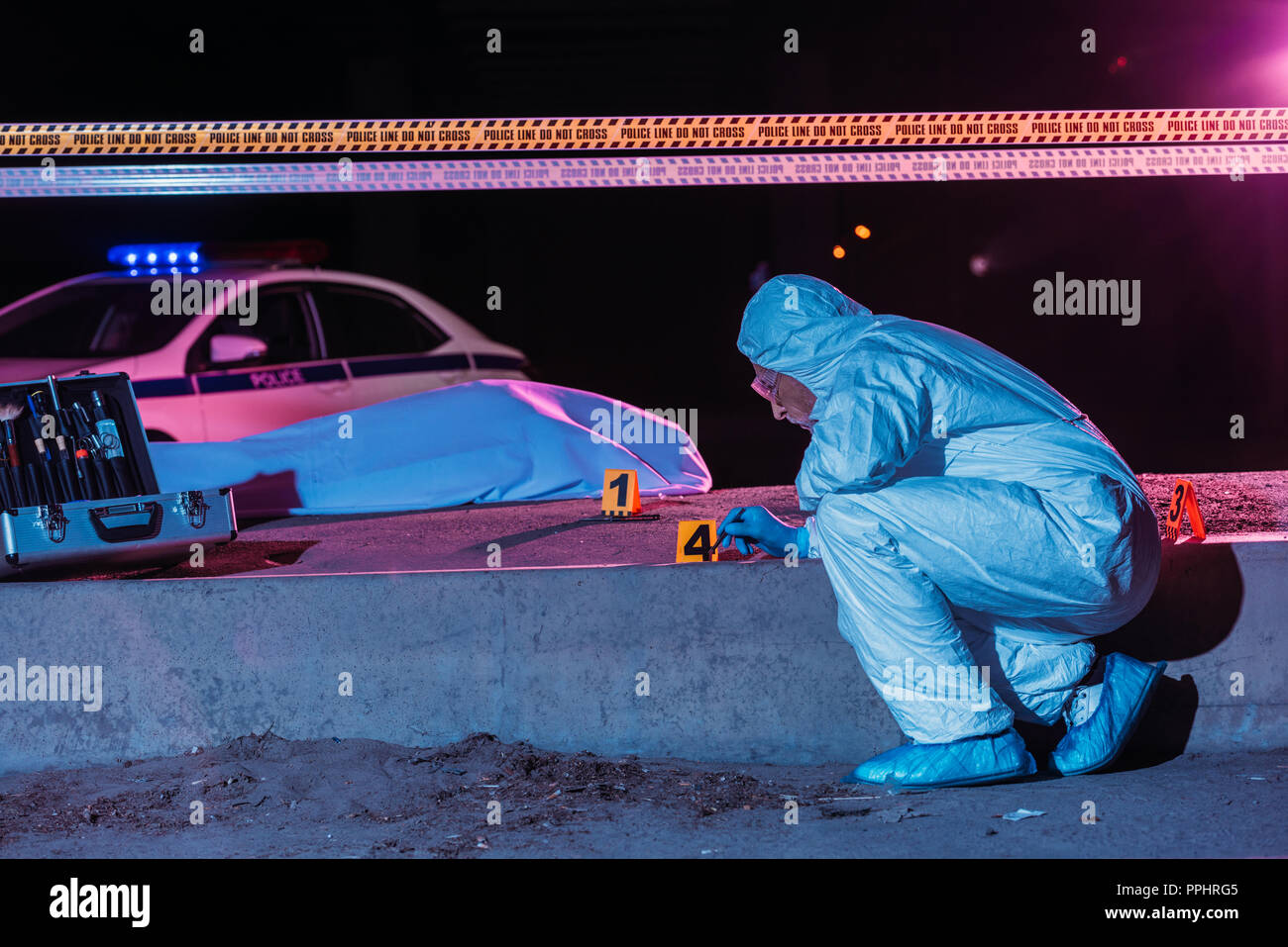 Male Criminologist In Protective Suit And Latex Gloves Collecting