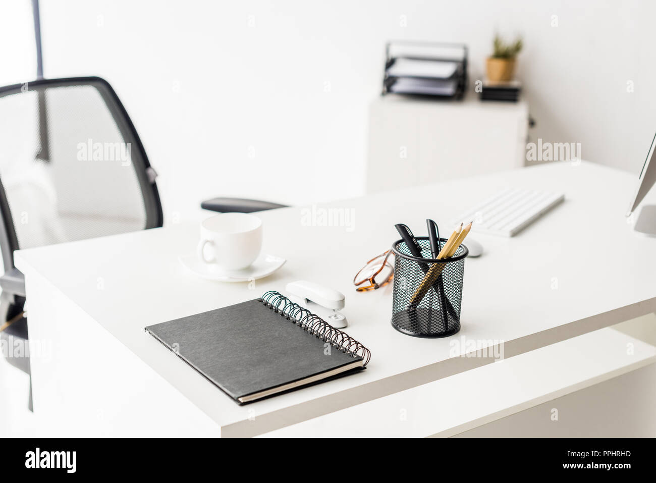 coffee cup and office supplies on white table at workplace Stock Photo ...