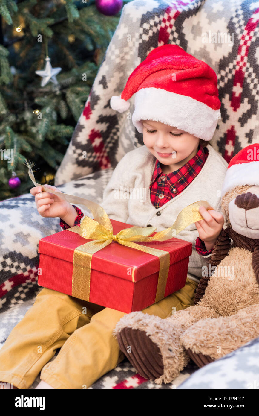 cute happy little boy opening christmas present Stock Photo - Alamy