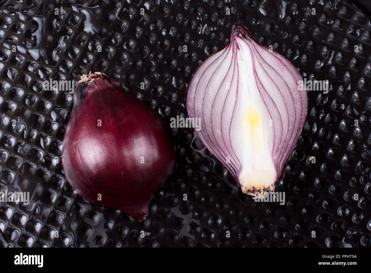 Red onion bulb cut in half on a certain background Stock Photo - Alamy
