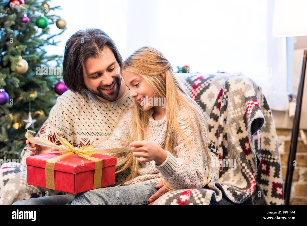 happy father and daughter opening christmas present Stock Photo - Alamy