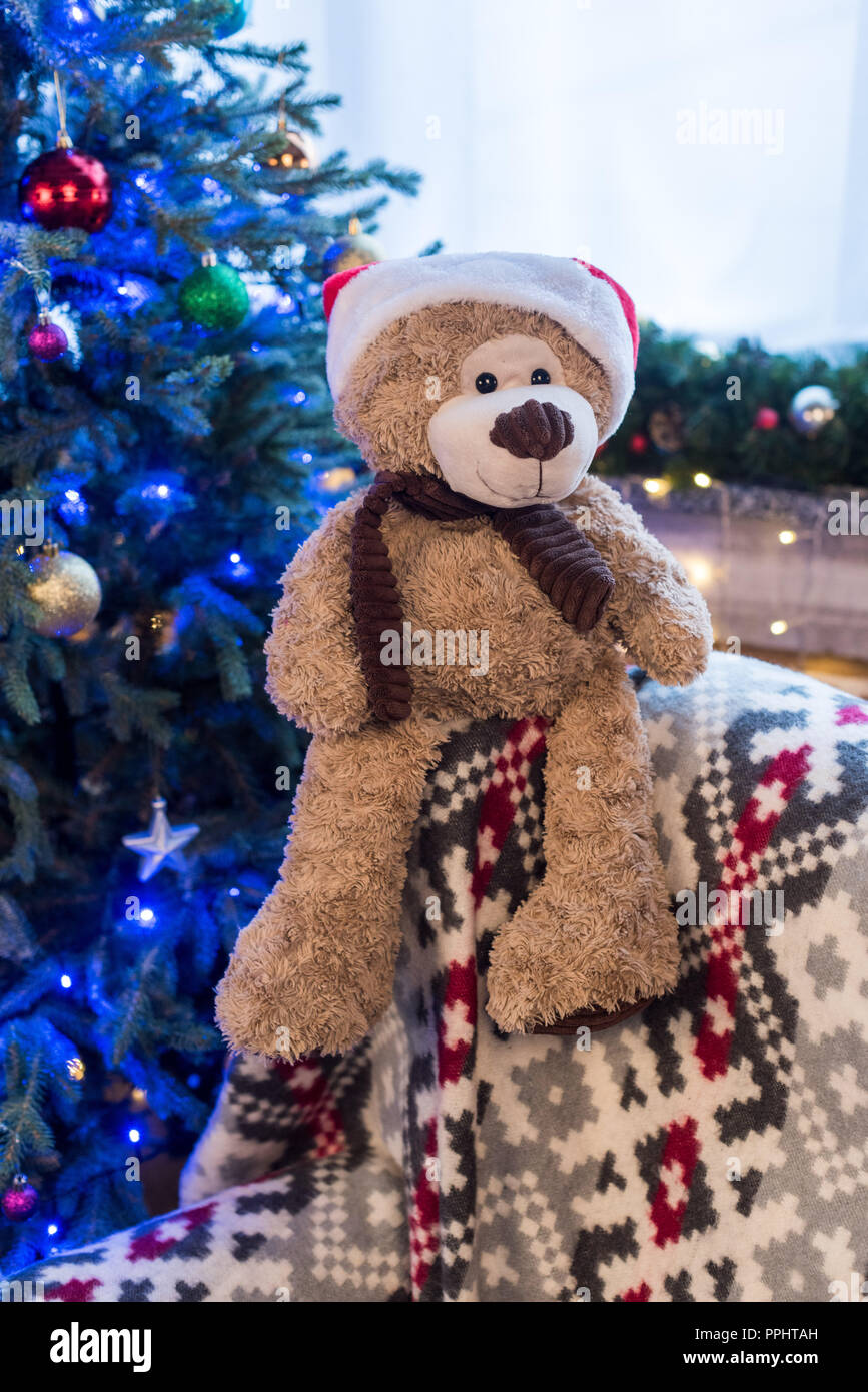 close-up view of teddy bear in santa hat and beautiful decorated ...