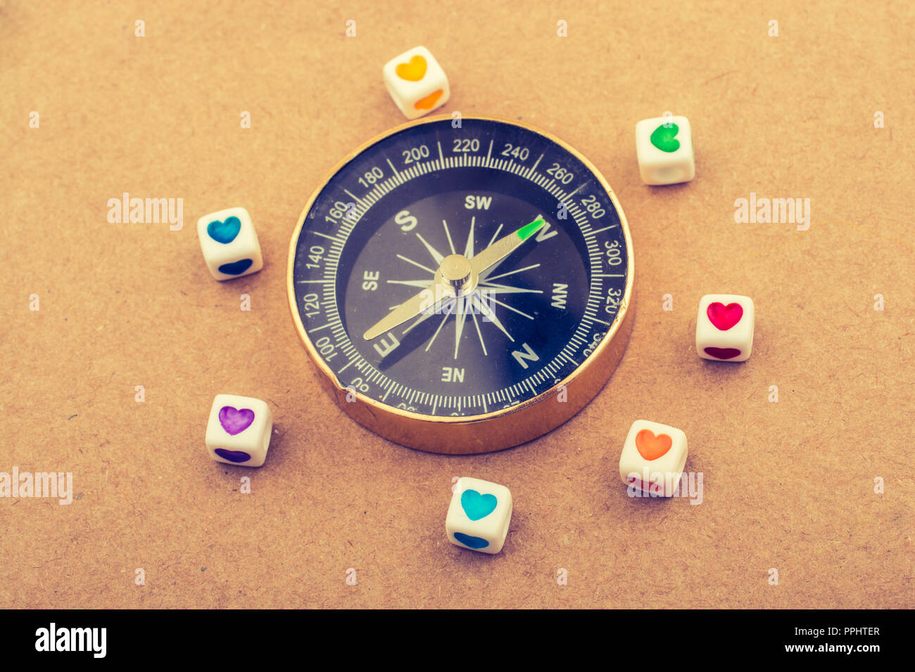 Heart cubes around a compass on canvas Stock Photo - Alamy
