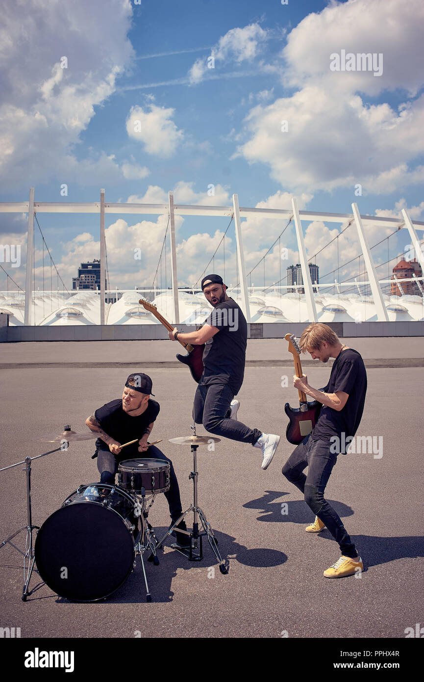 rock band in black clothing playing music on street Stock Photo - Alamy