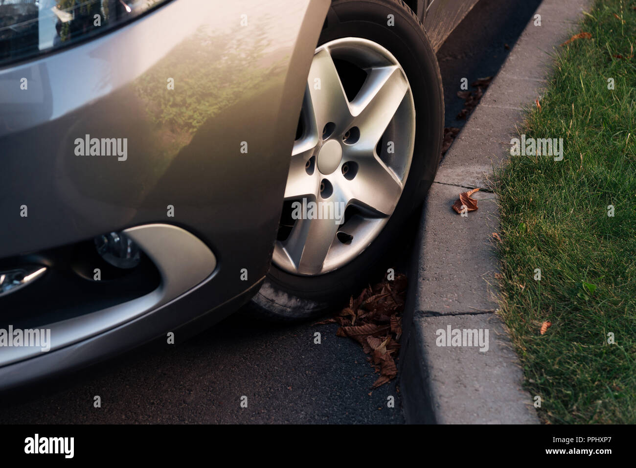 detail of grey shiny car on parking lot and green grass Stock Photo - Alamy