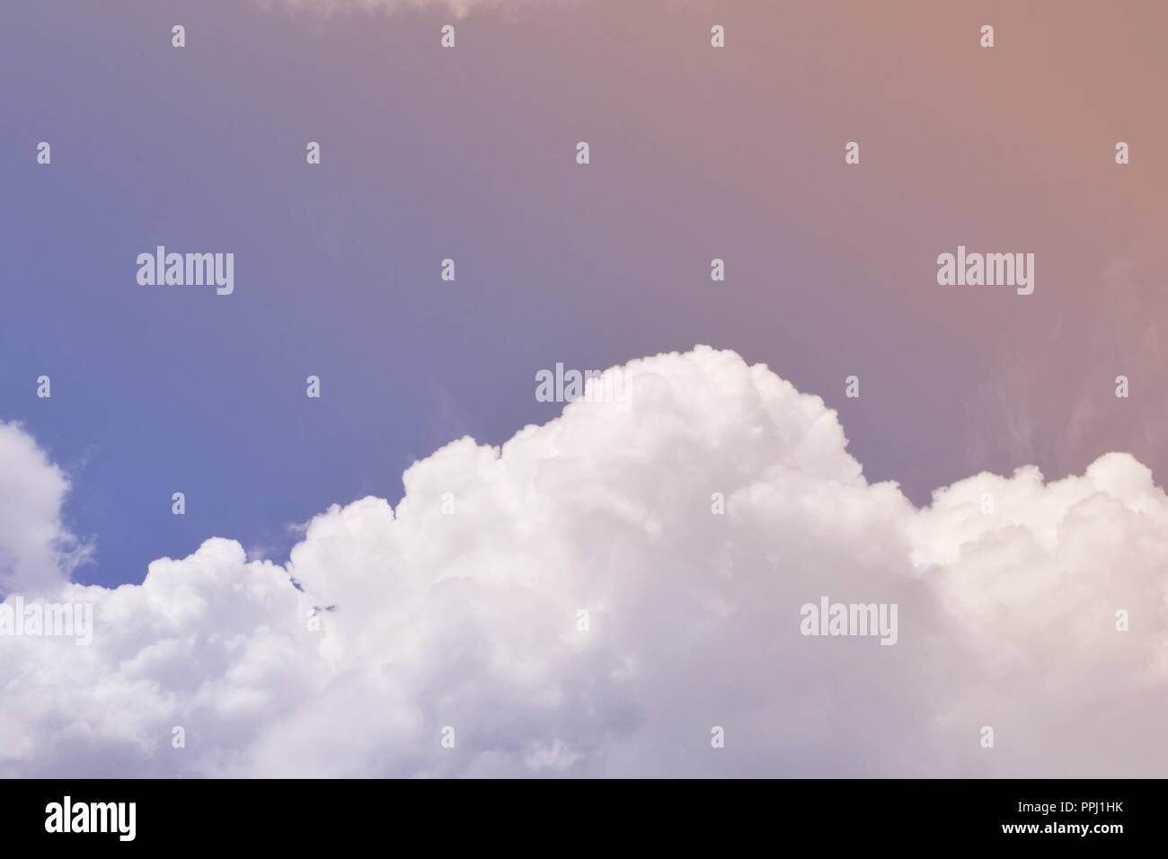 Nature background. Fluffy soft clouds in sky toned Stock Photo - Alamy
