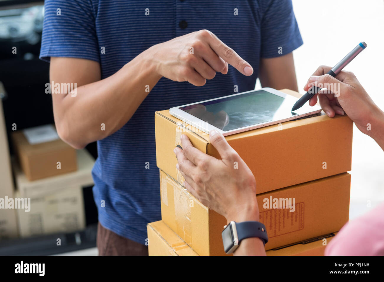 woman courier holding a parcel Shipping Mail appending signature ...