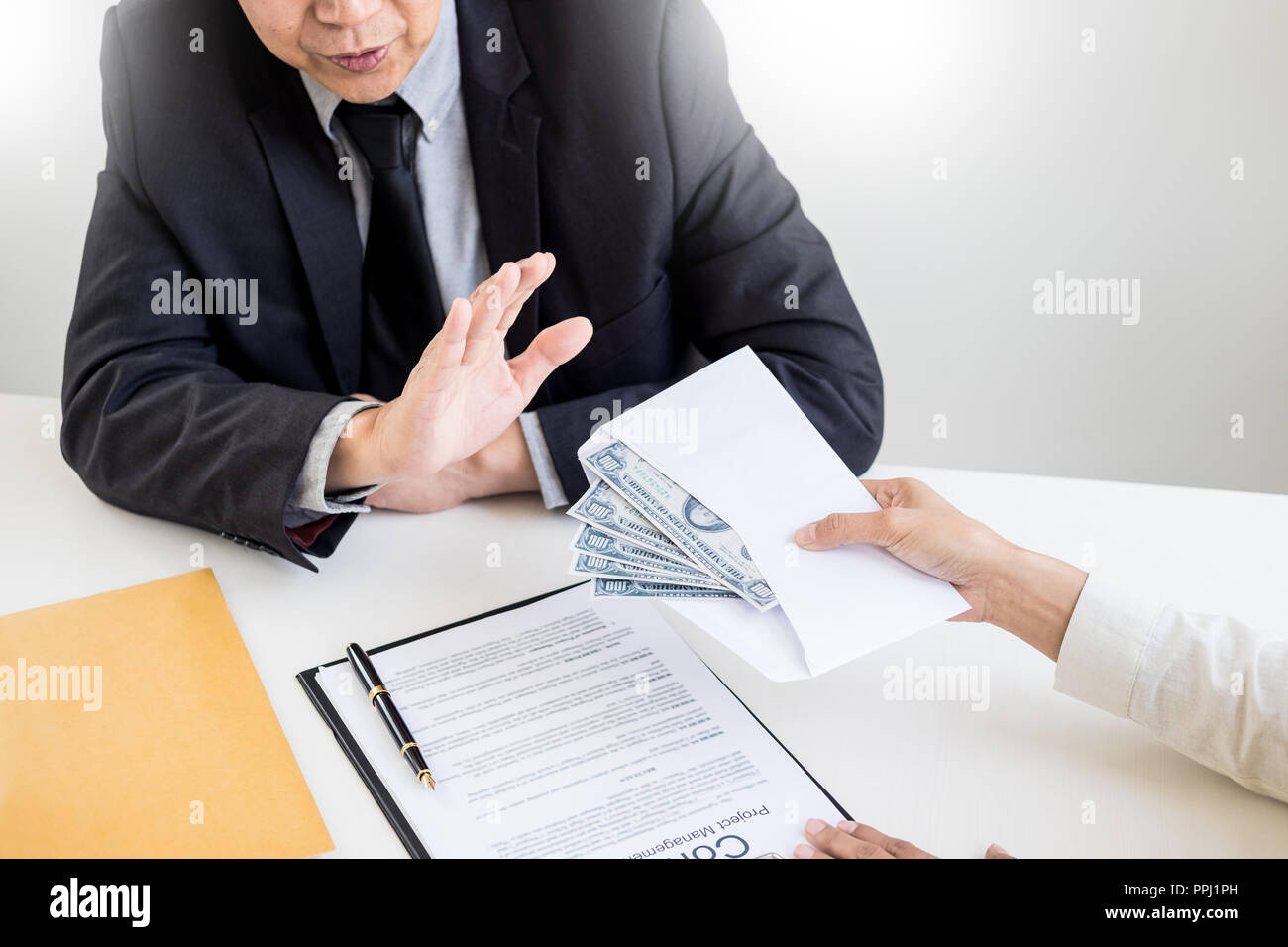 Businessman refusing or rejecting money in the envelope - anti bribery ...