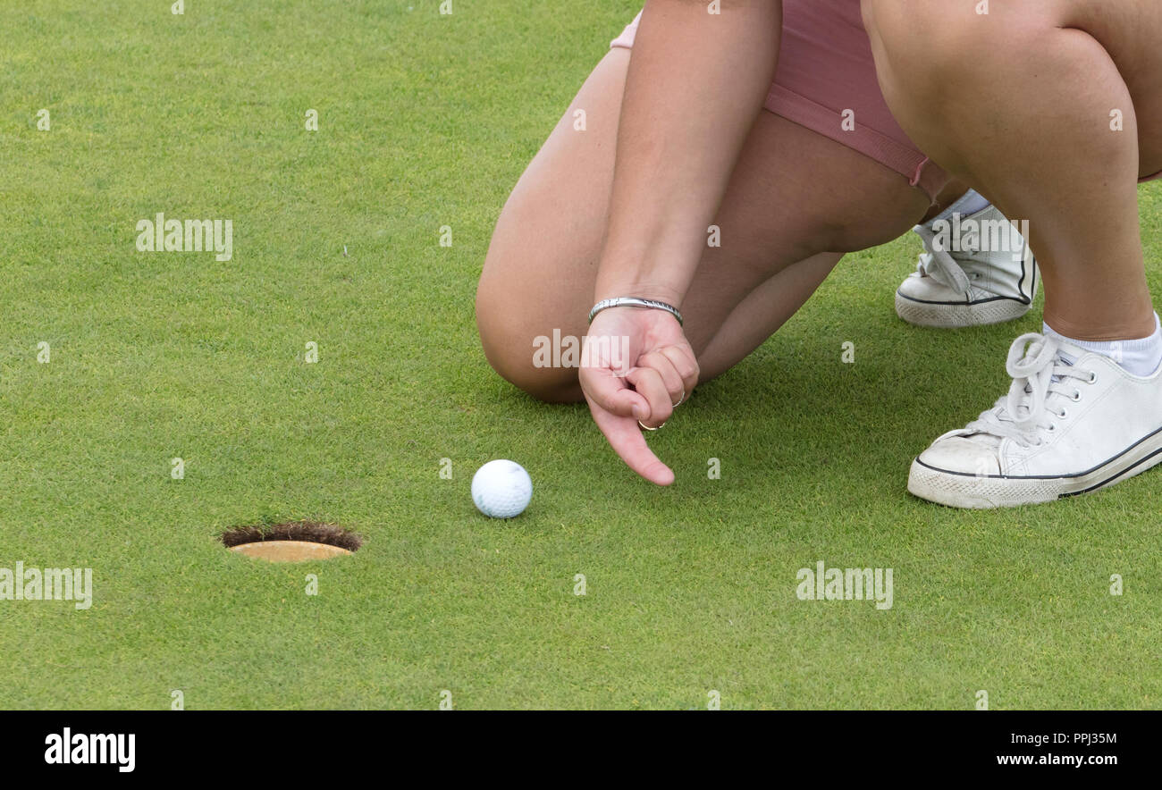 Concept of fun; Playing golf with a finger - Cheating Stock Photo - Alamy