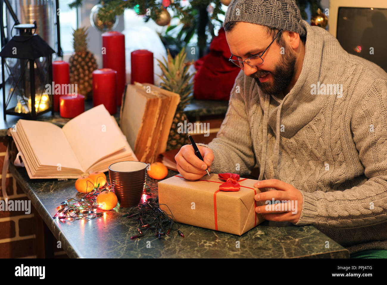beard man writing christmas gifts on a table Stock Photo - Alamy