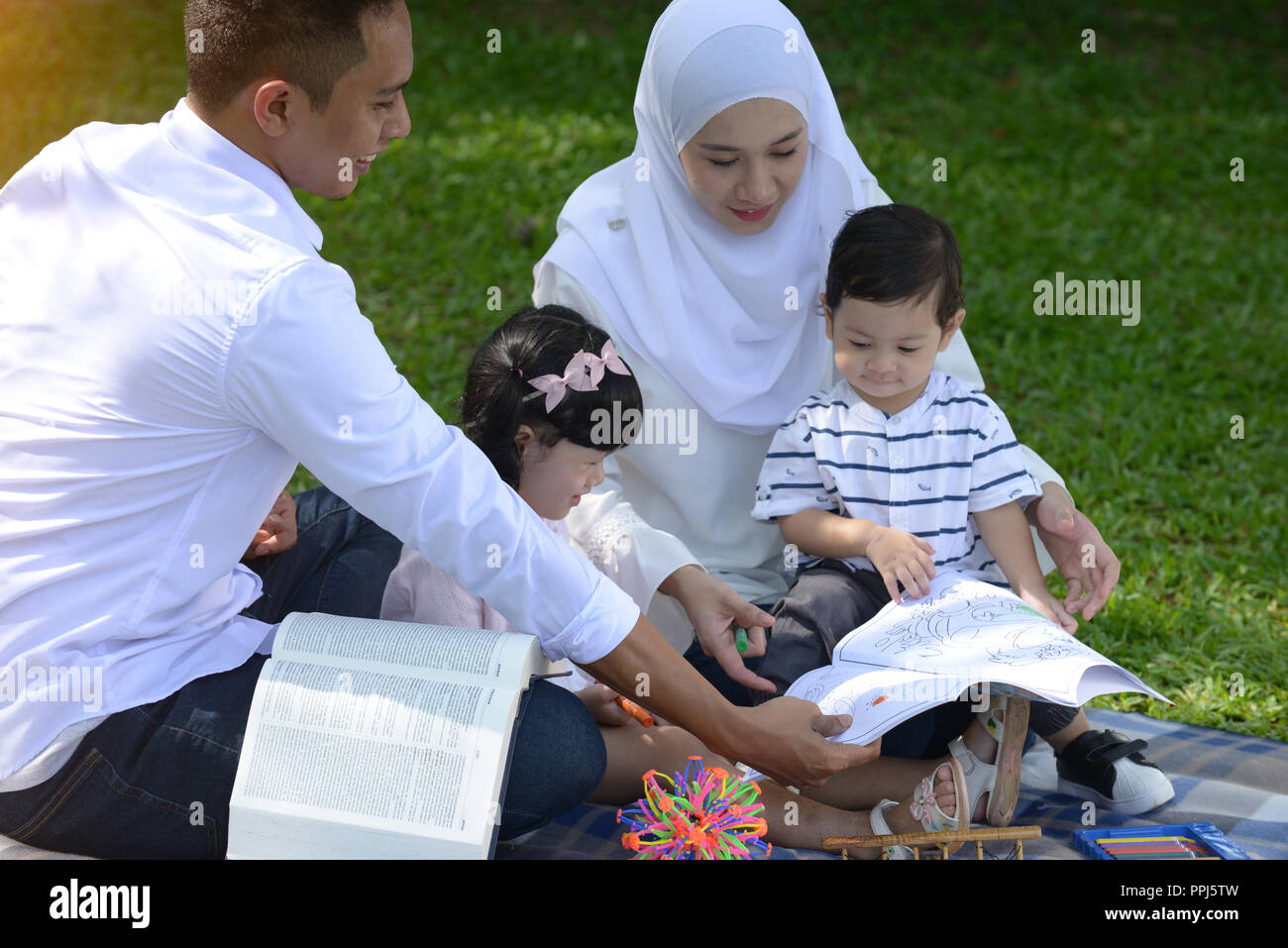 malay family reading outdoor Stock Photo - Alamy