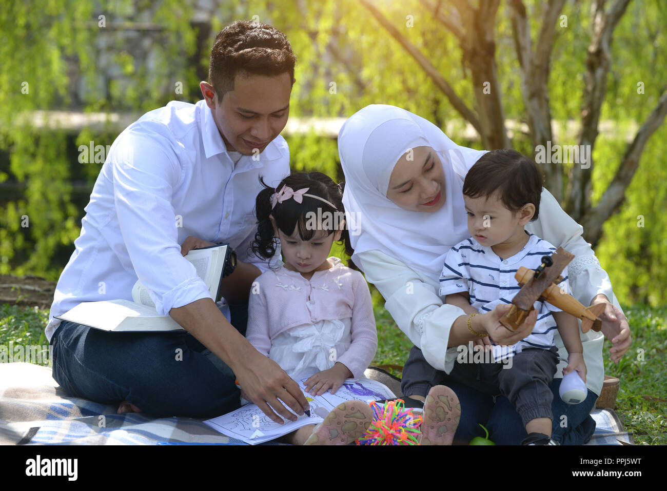 malay family reading outdoor Stock Photo - Alamy