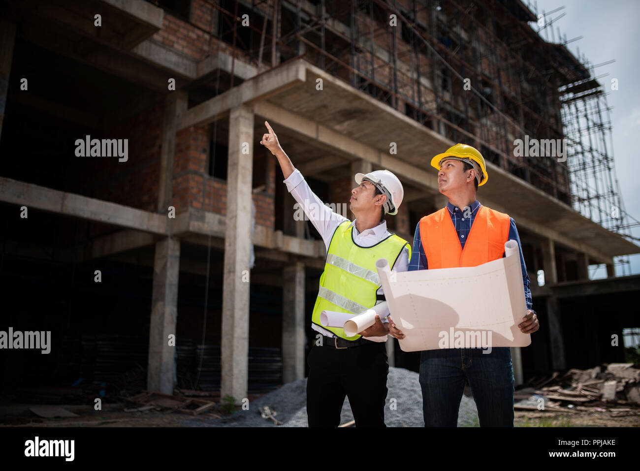 two construction engineer working in construction site and management ...