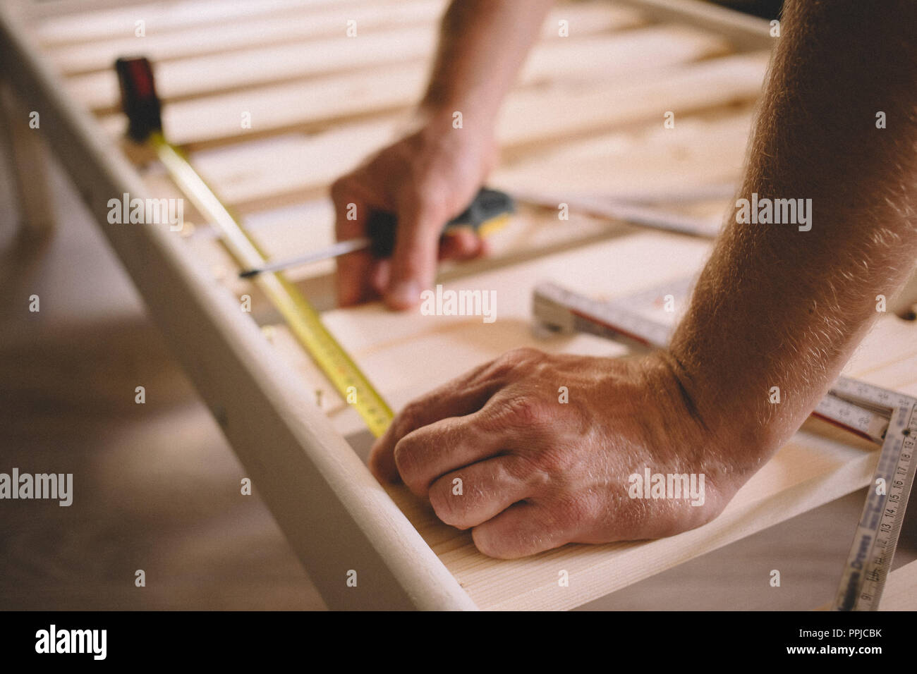 close up hands of a man, a man screws a screwdriver, instruction and ...
