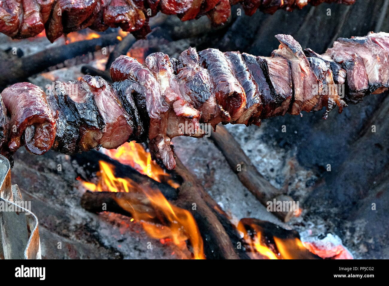 Skewered meat on the fire Stock Photo - Alamy