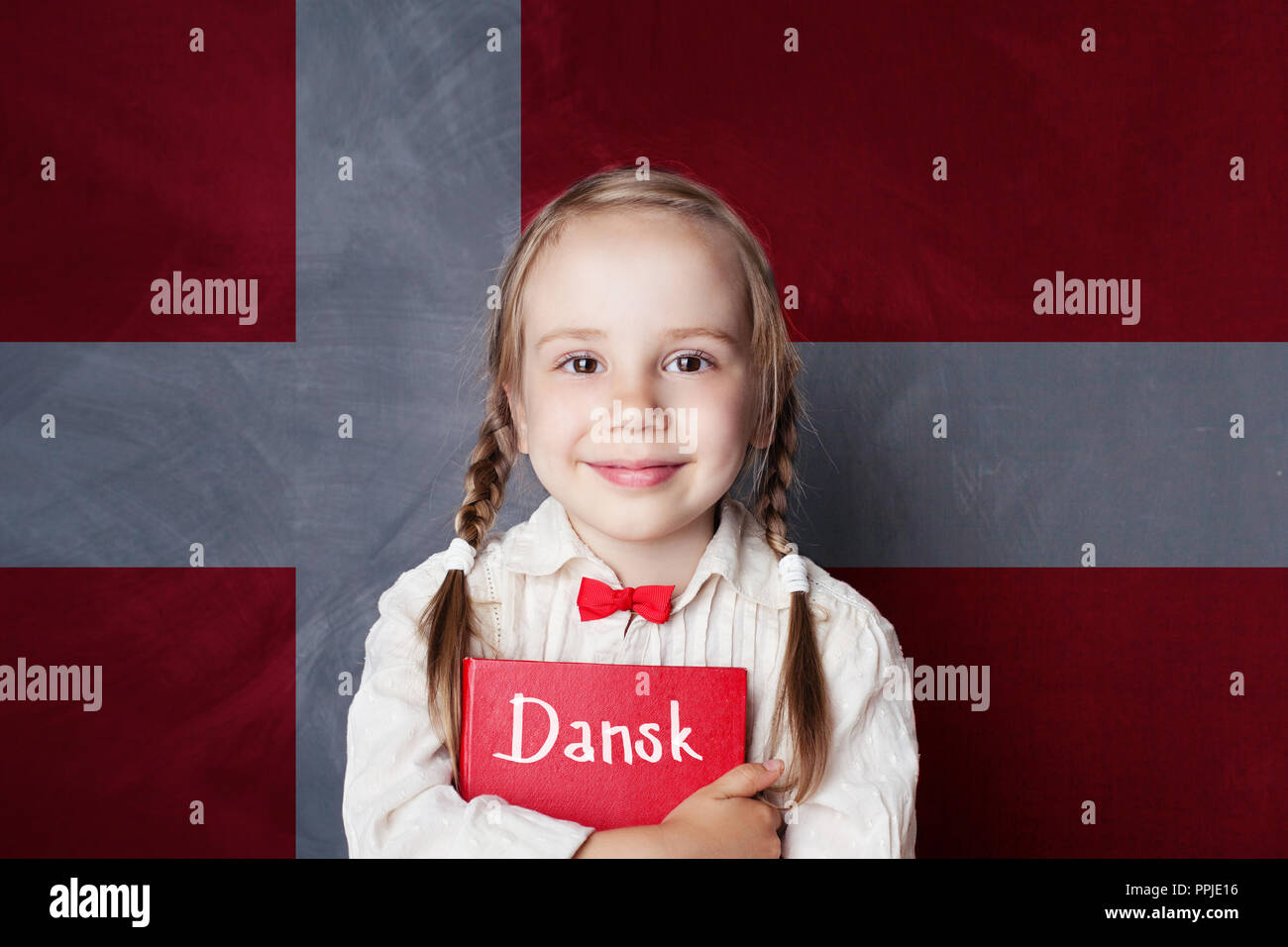 Danish concept. Child girl student with book against the Danish flag ...