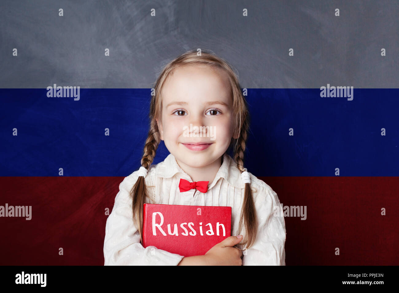 Russian concept. Child girl student with red book on the Russian flag ...