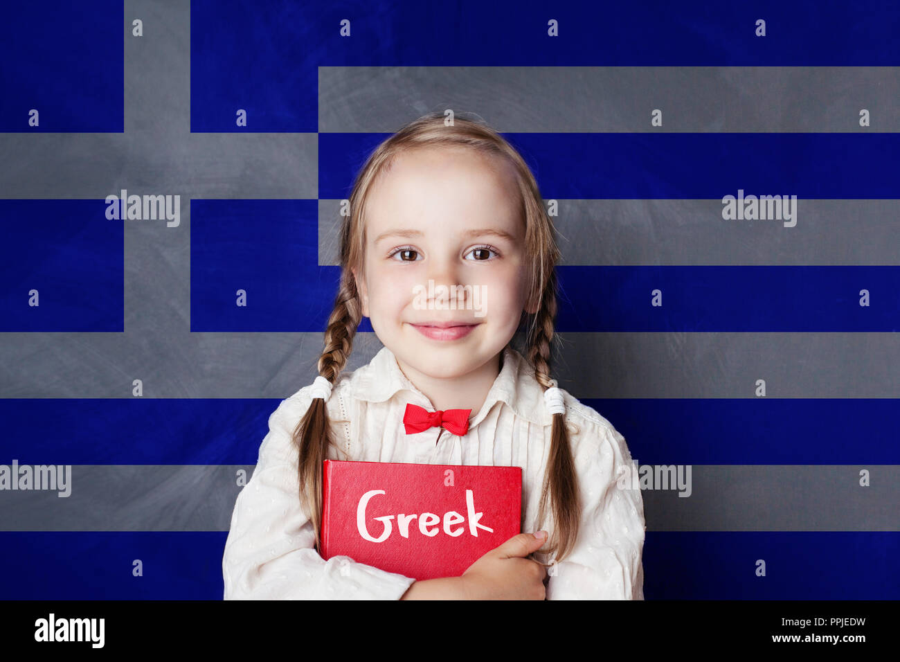 Greek language concept. Happy litte child student with book against the ...