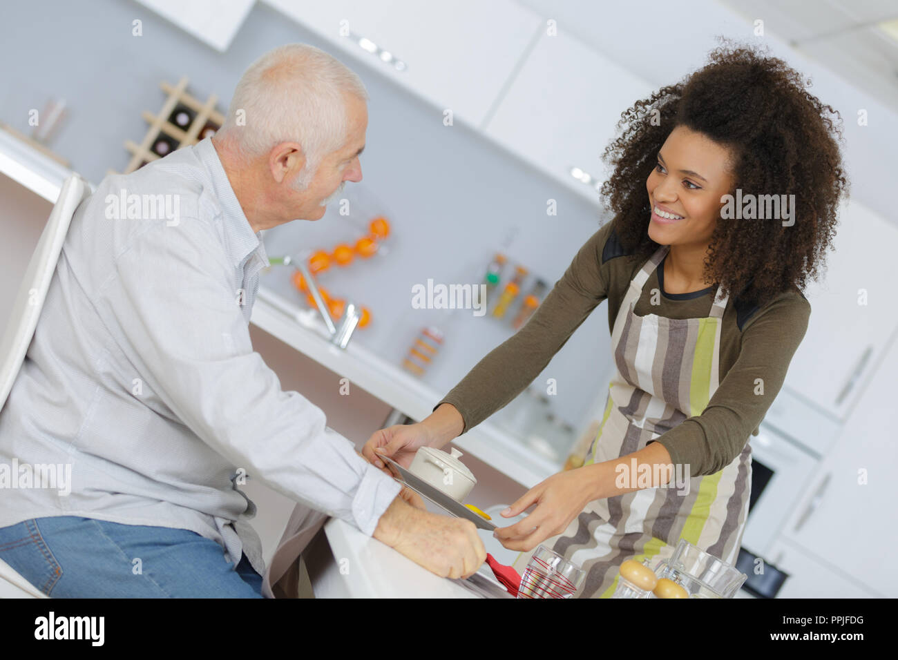 health care worker helping an elderly man Stock Photo - Alamy