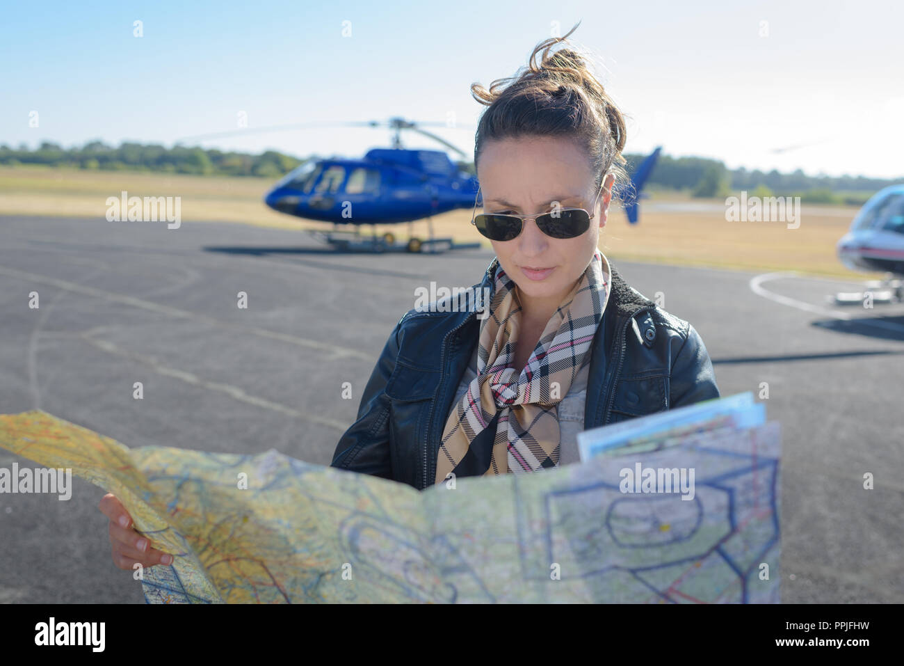 woman helicopter pilot reading map Stock Photo - Alamy
