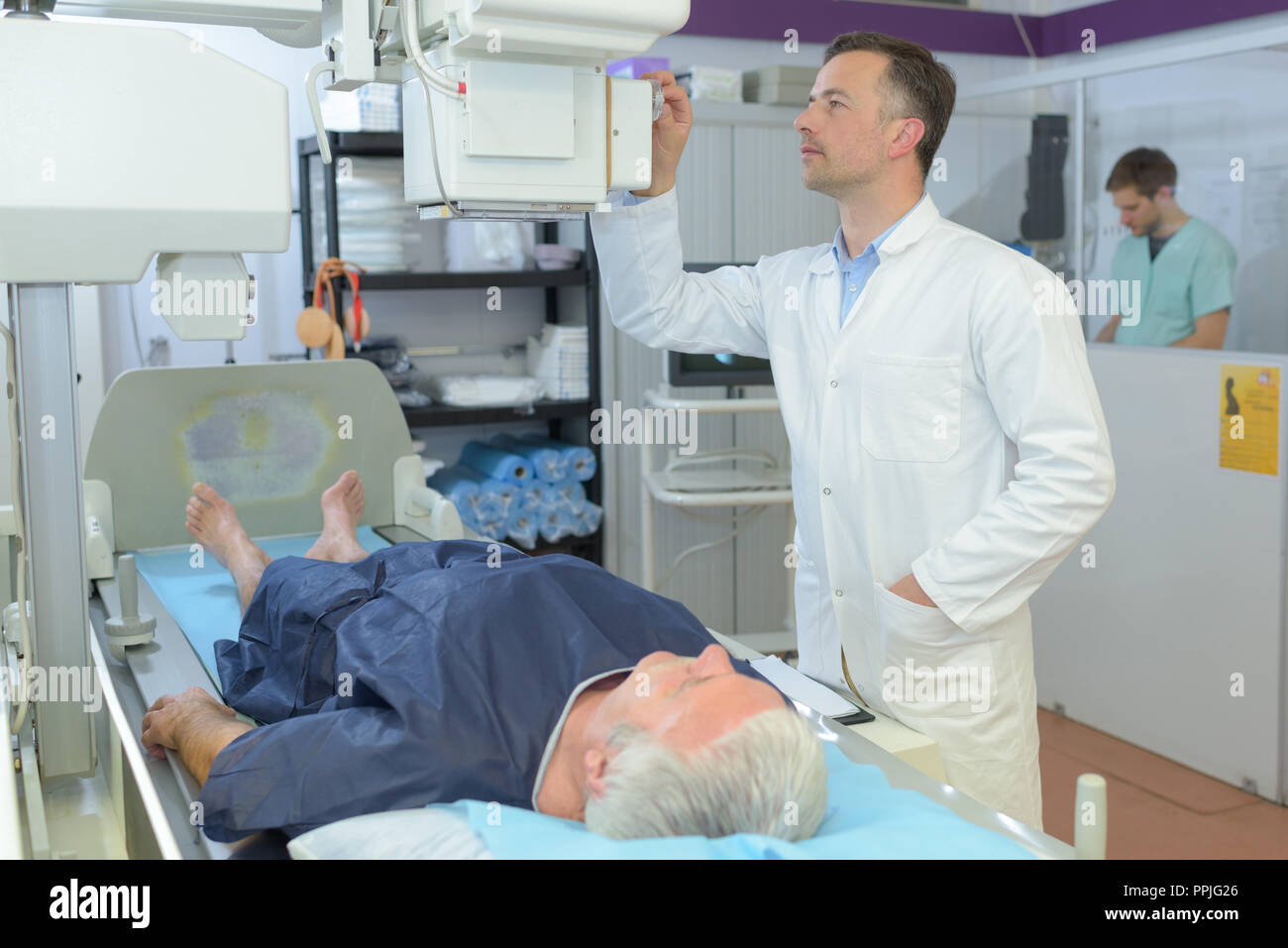 female doctor with male patient undergoing scanner Stock Photo - Alamy